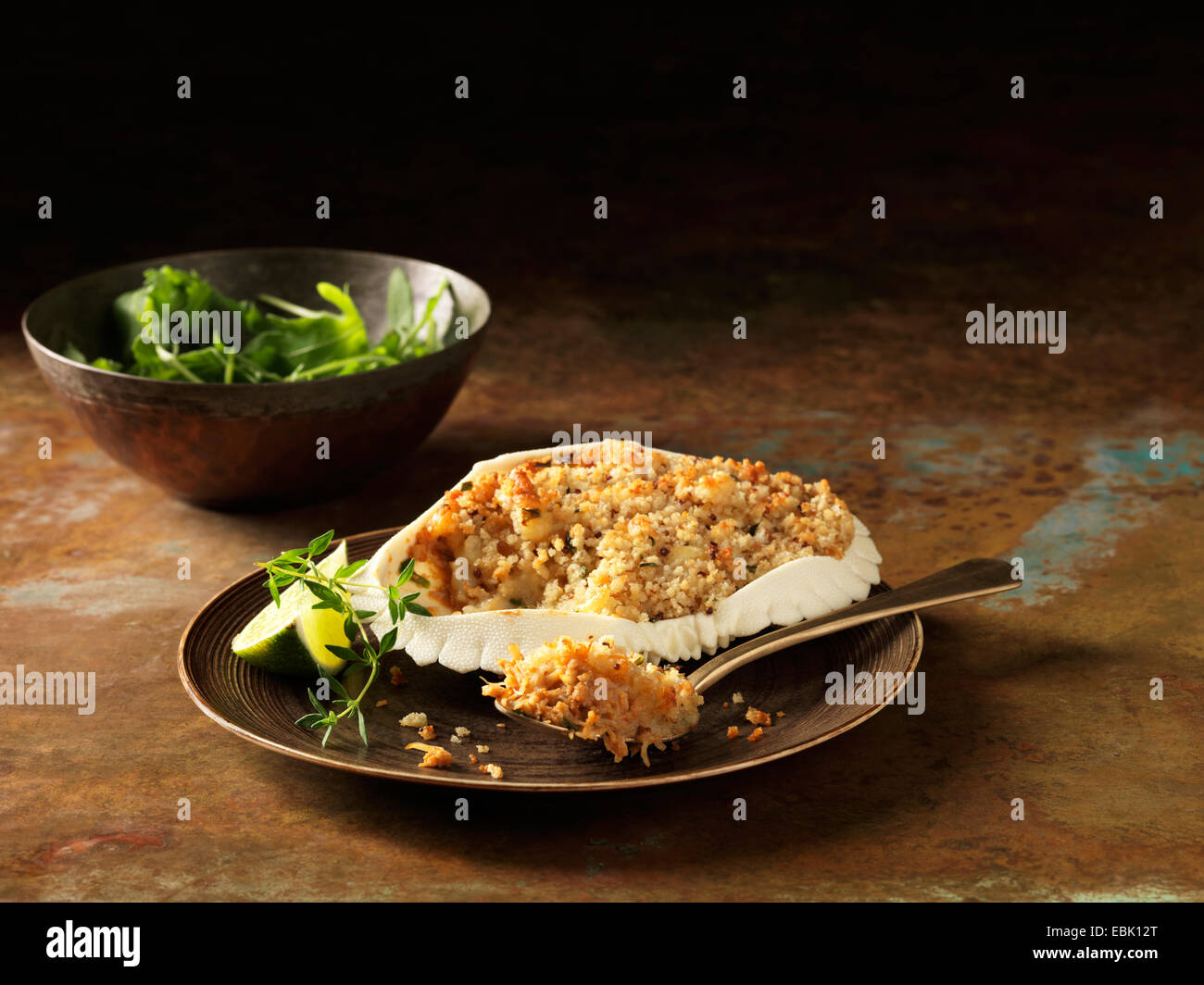 Orkney Crab gratin in shell with rocket and slice lime and thyme ...