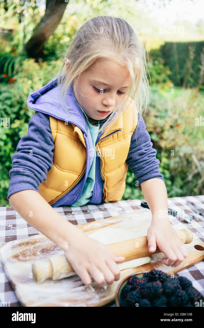 Girl rolling pastry Stock Photo - Alamy