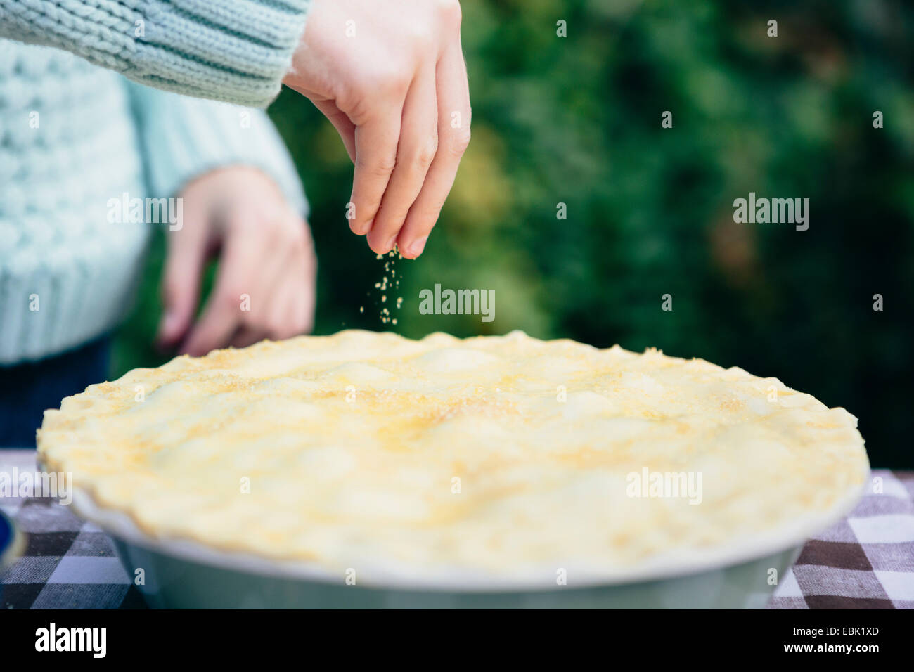 Girl sprinkling sugar on homemade pie Stock Photo - Alamy