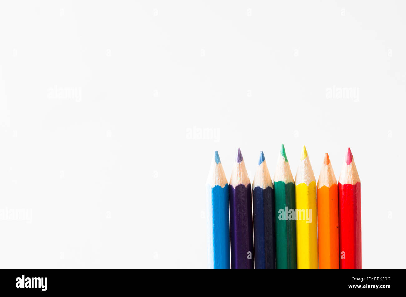 Colored pencils lined up in a row in the order of shade Stock Photo - Alamy