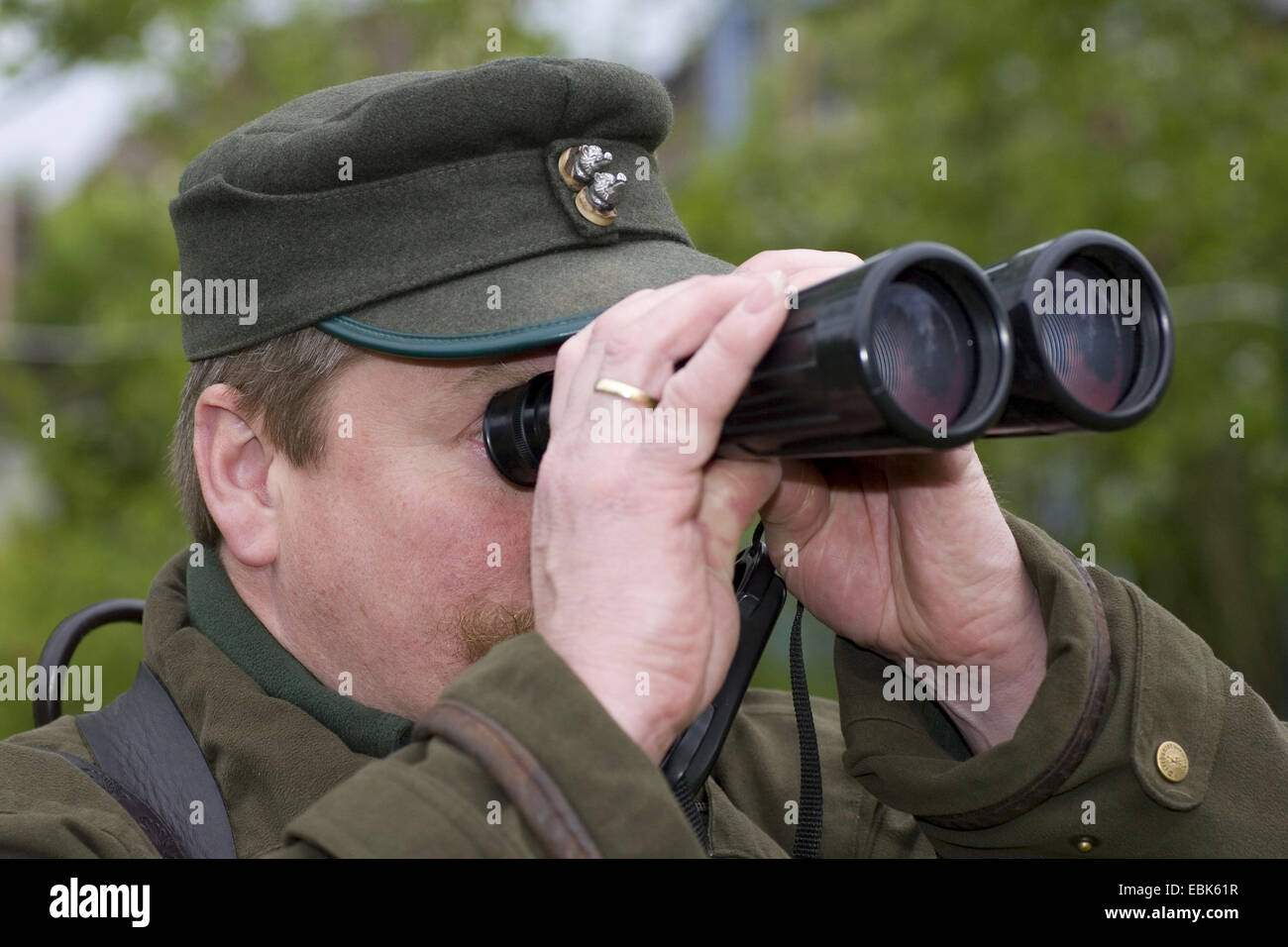portrait of a hunter looking through a binocular Stock Photo - Alamy