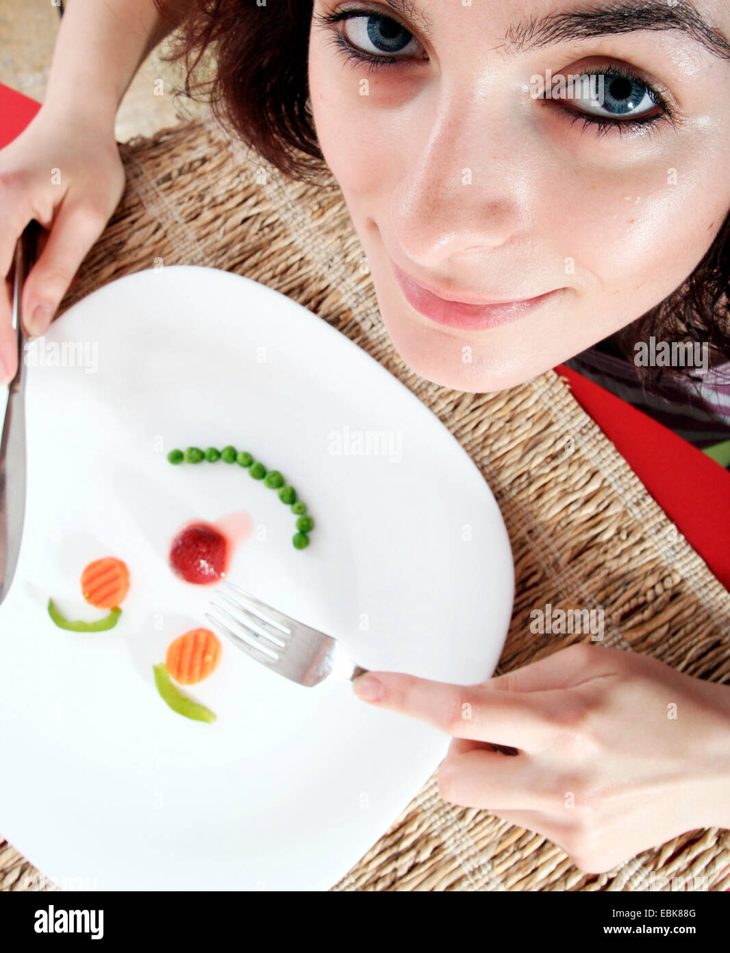 symbol picture 'diet': young girl starting to eat a meal consisting of ...