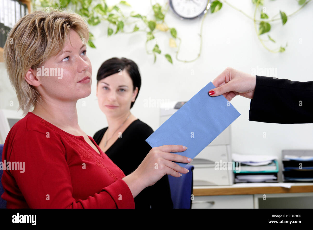 woman getting pink slip Stock Photo - Alamy