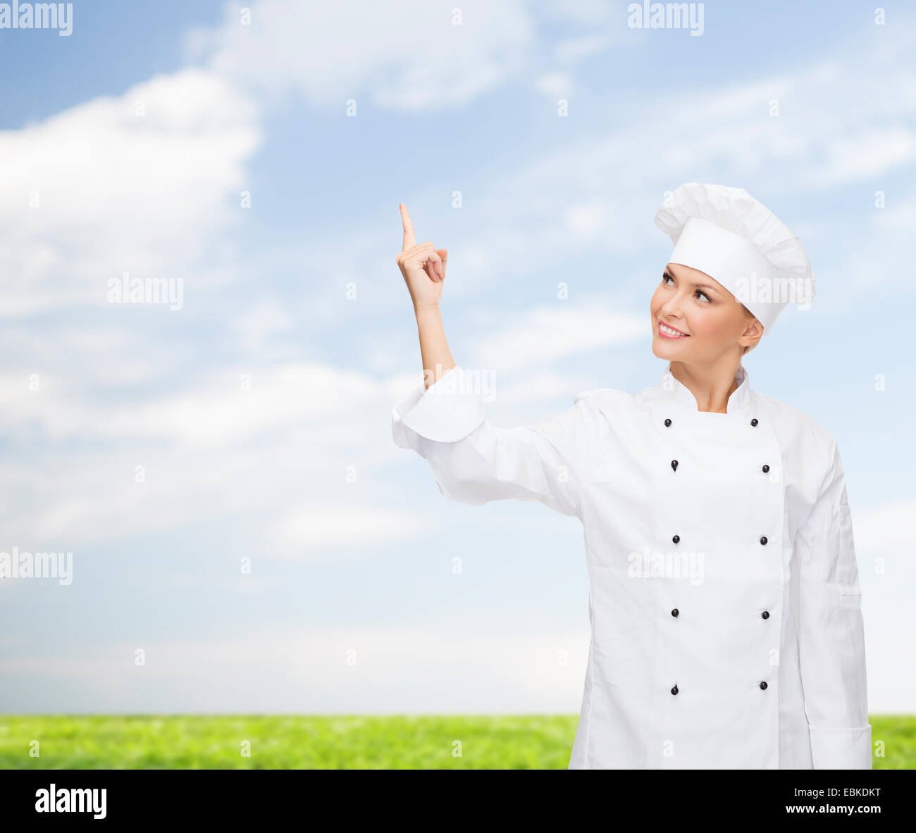 smiling female chef pointing finger to something Stock Photo - Alamy