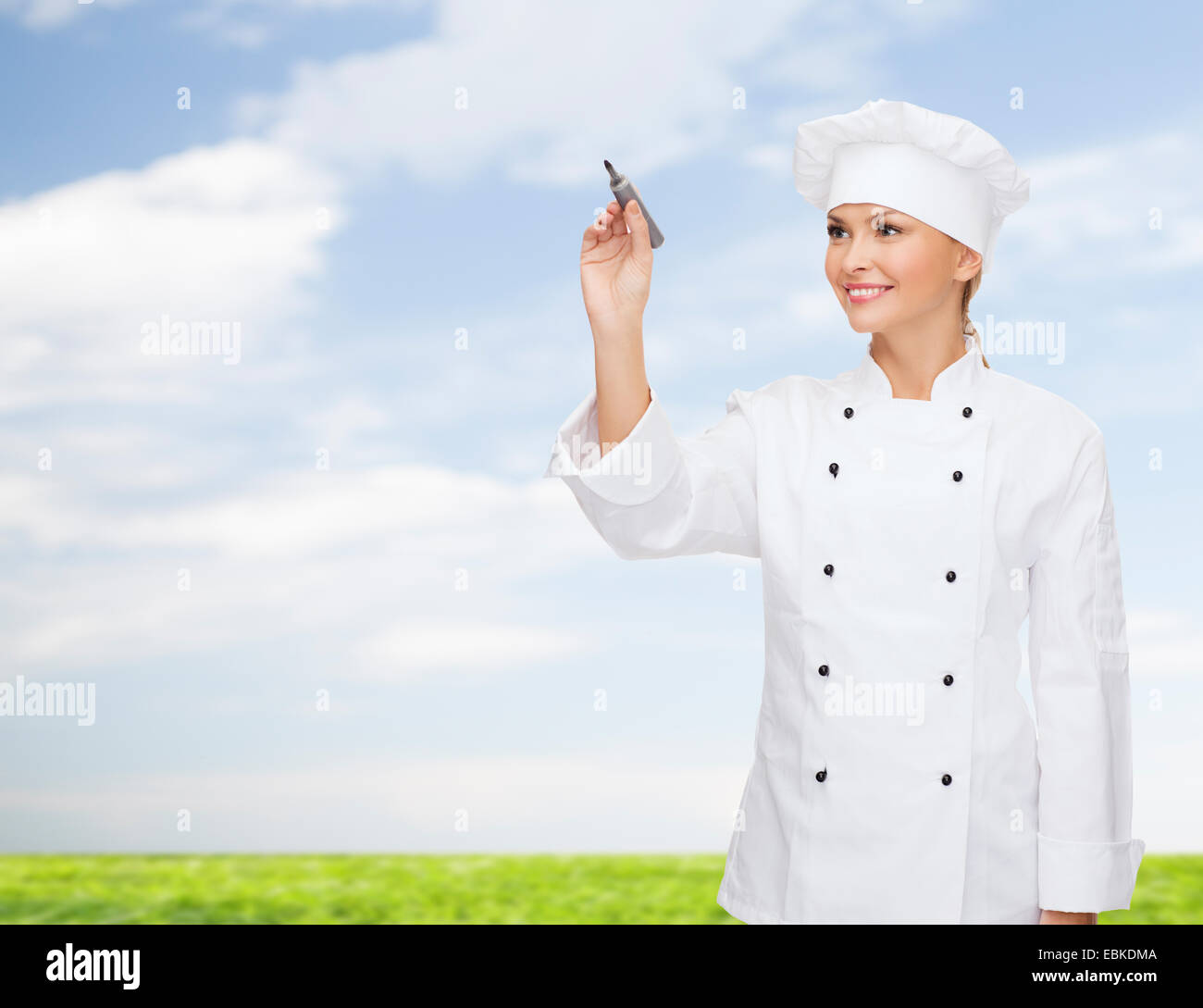 smiling female chef writing something on air Stock Photo - Alamy