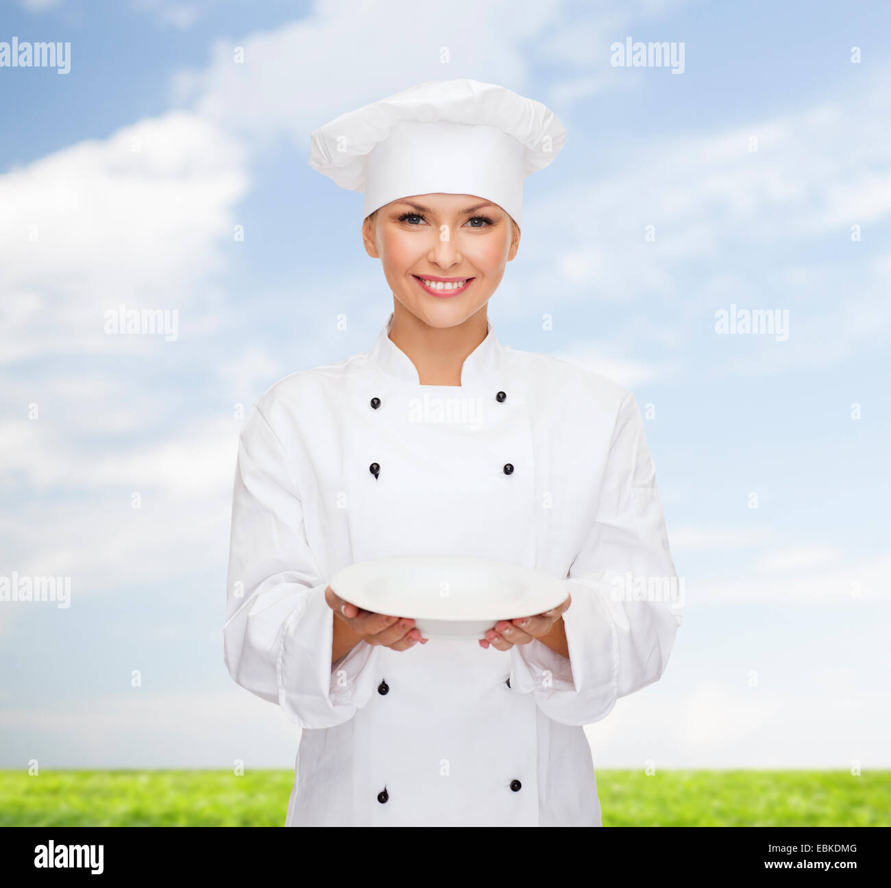smiling female chef with empty plate Stock Photo - Alamy