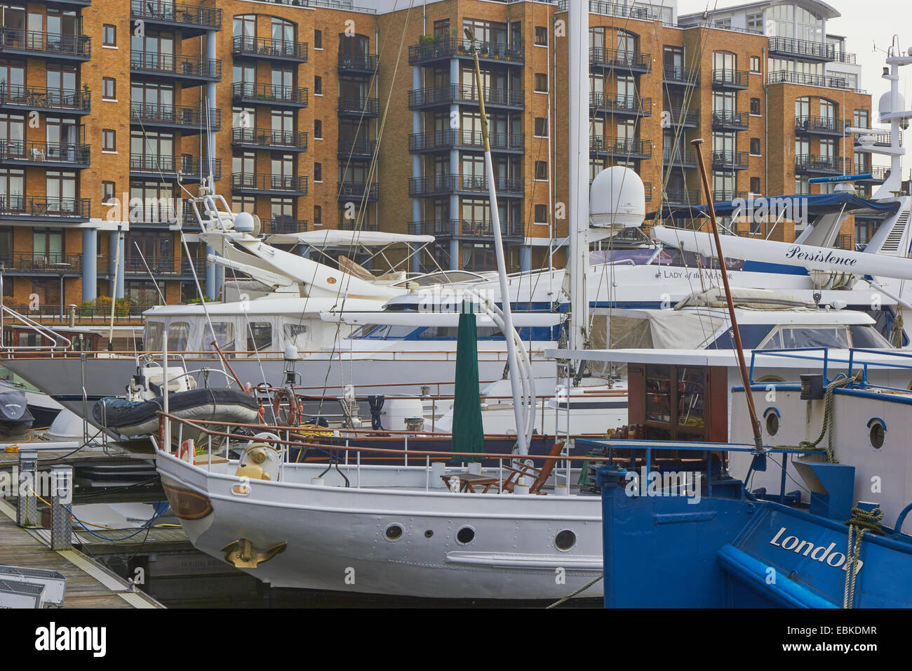 Boats moored by luxury upmarket apartments in St Katherine Docks east ...