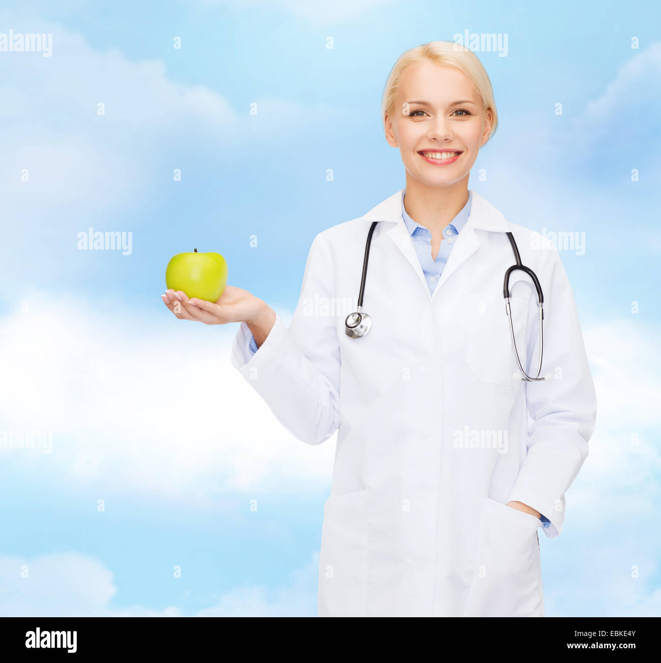 Happy doctor holding an apple hi-res stock photography and images - Alamy