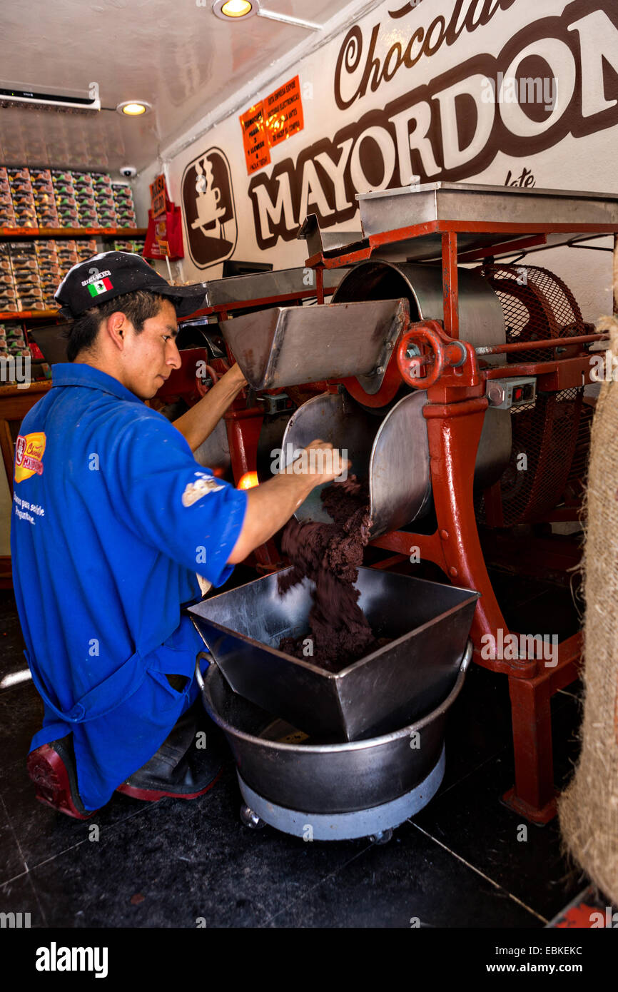 Workers use grinding and mixing machines used to mix chocolate and ...