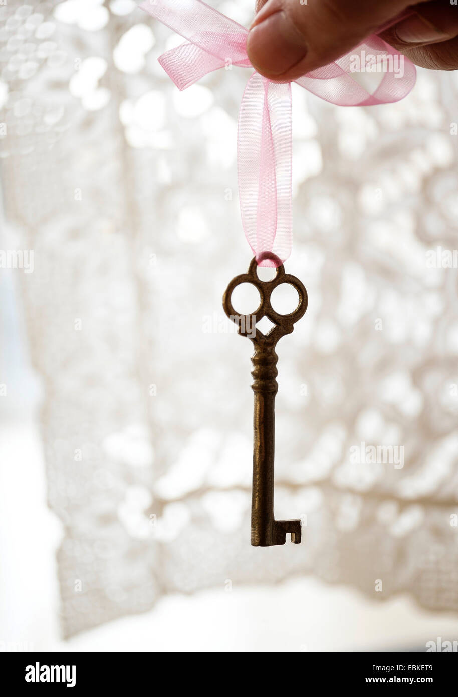 Studio shot of hand holding antique key Stock Photo - Alamy