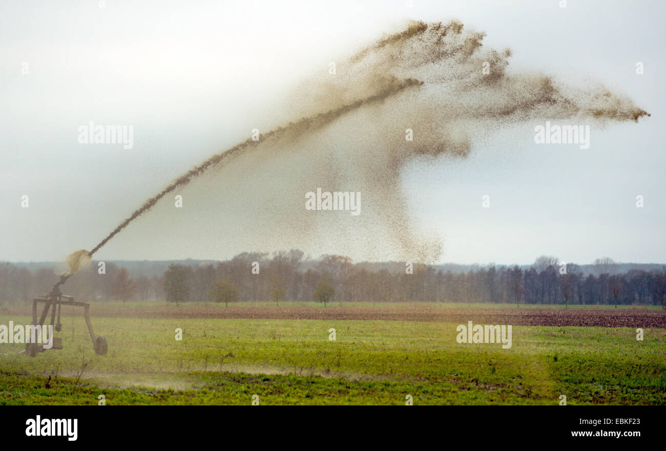 A sprinkler dispenses slurry on a field near Sachsendorf, Germany, 25 ...