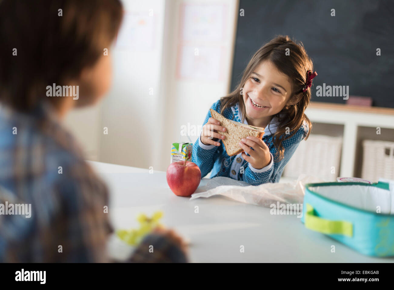 Pupils (6-7) eating lunch in classroom Stock Photo - Alamy