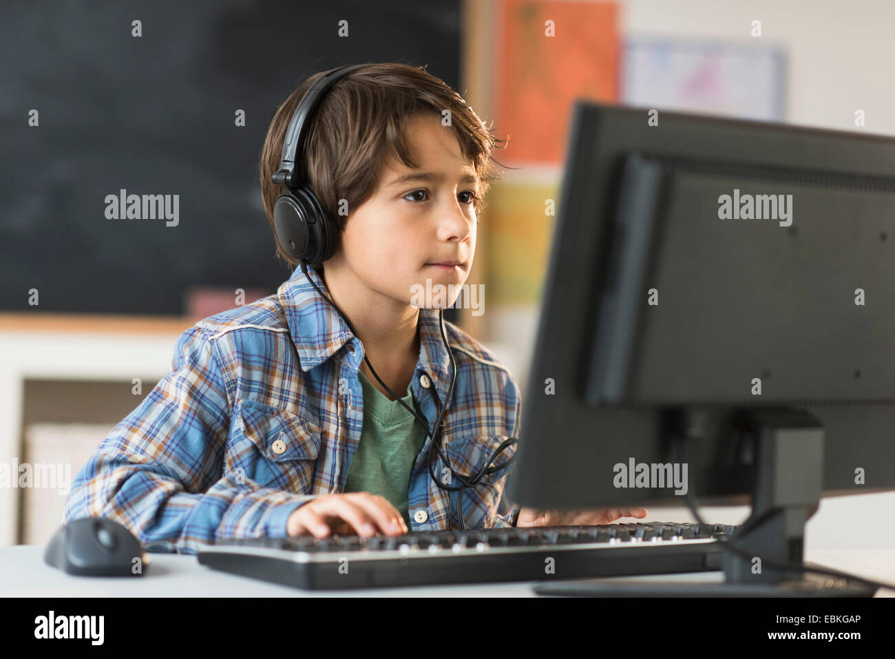 Boy using computer with headphones hi-res stock photography and images ...