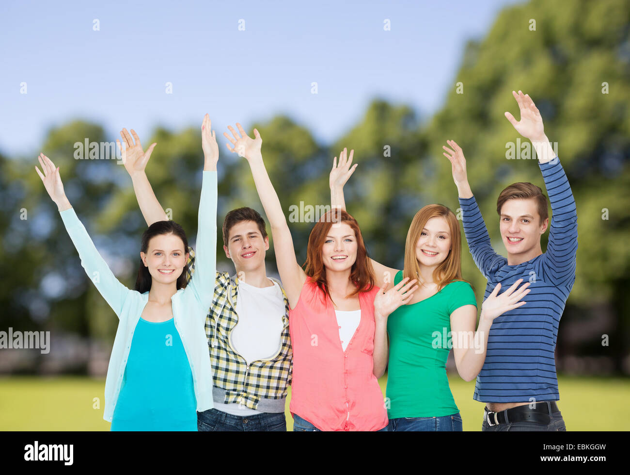 group of smiling students waving hands Stock Photo - Alamy