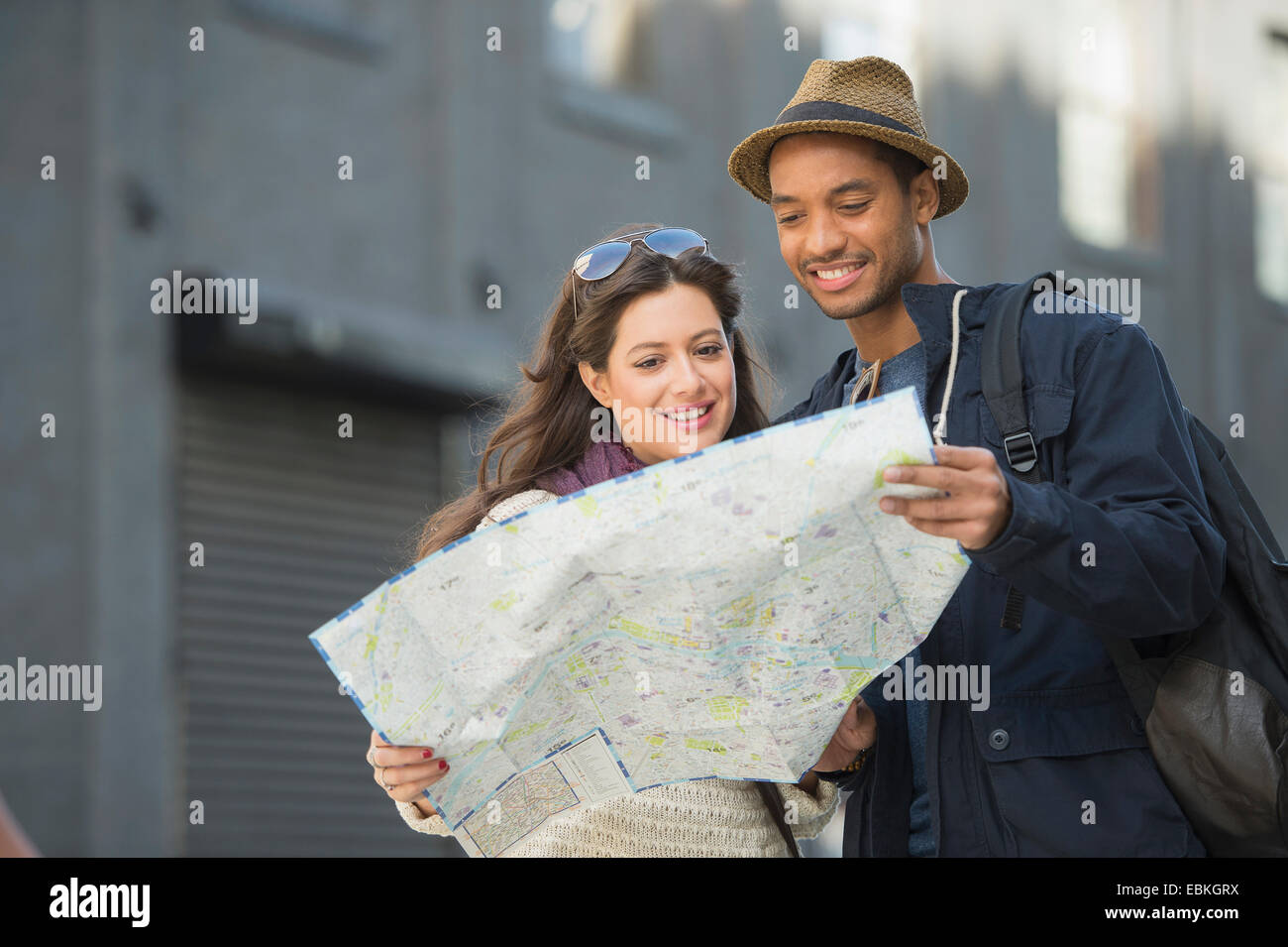 Couple reading map on street Stock Photo - Alamy