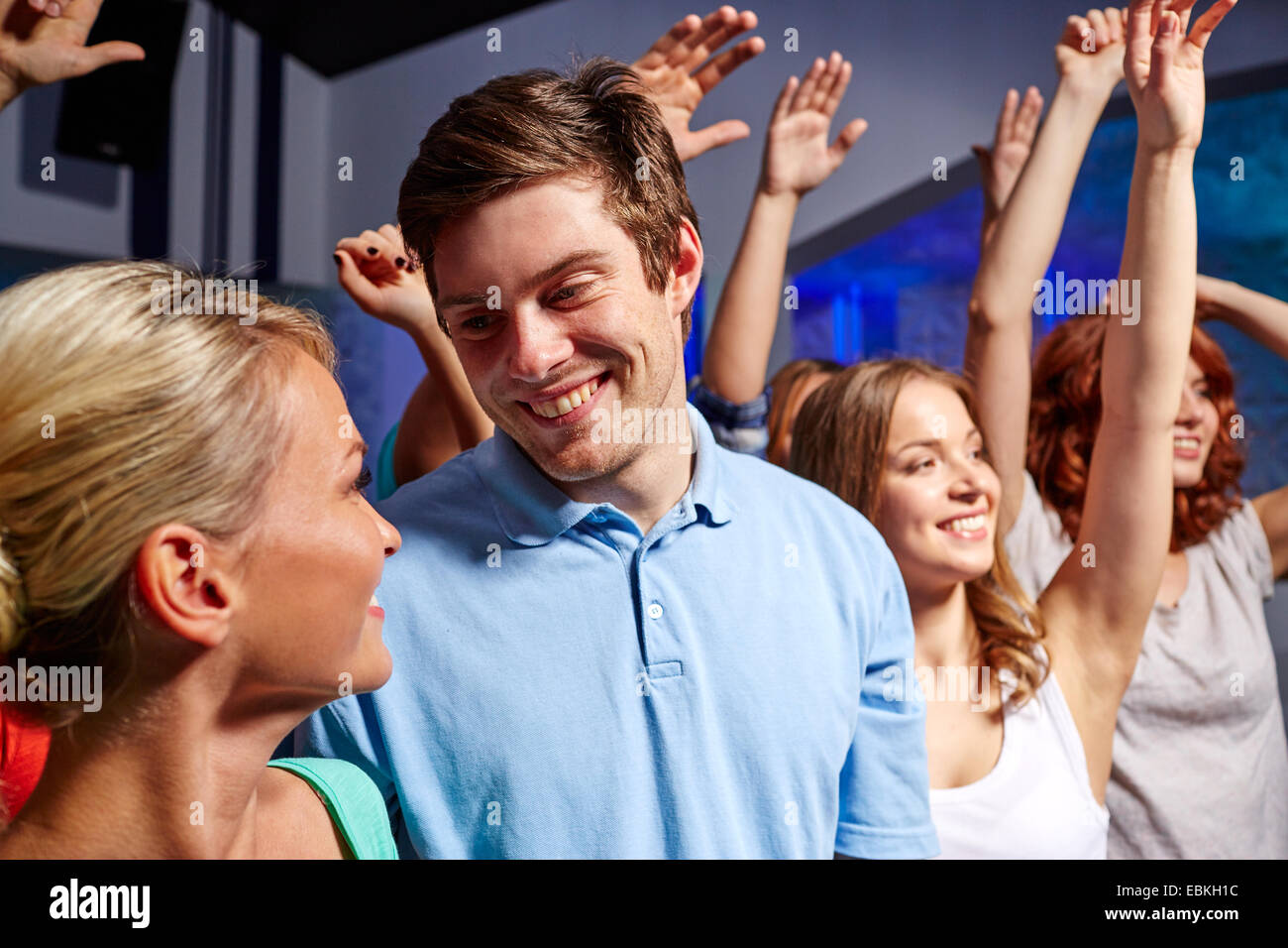 smiling friends at concert in club Stock Photo - Alamy