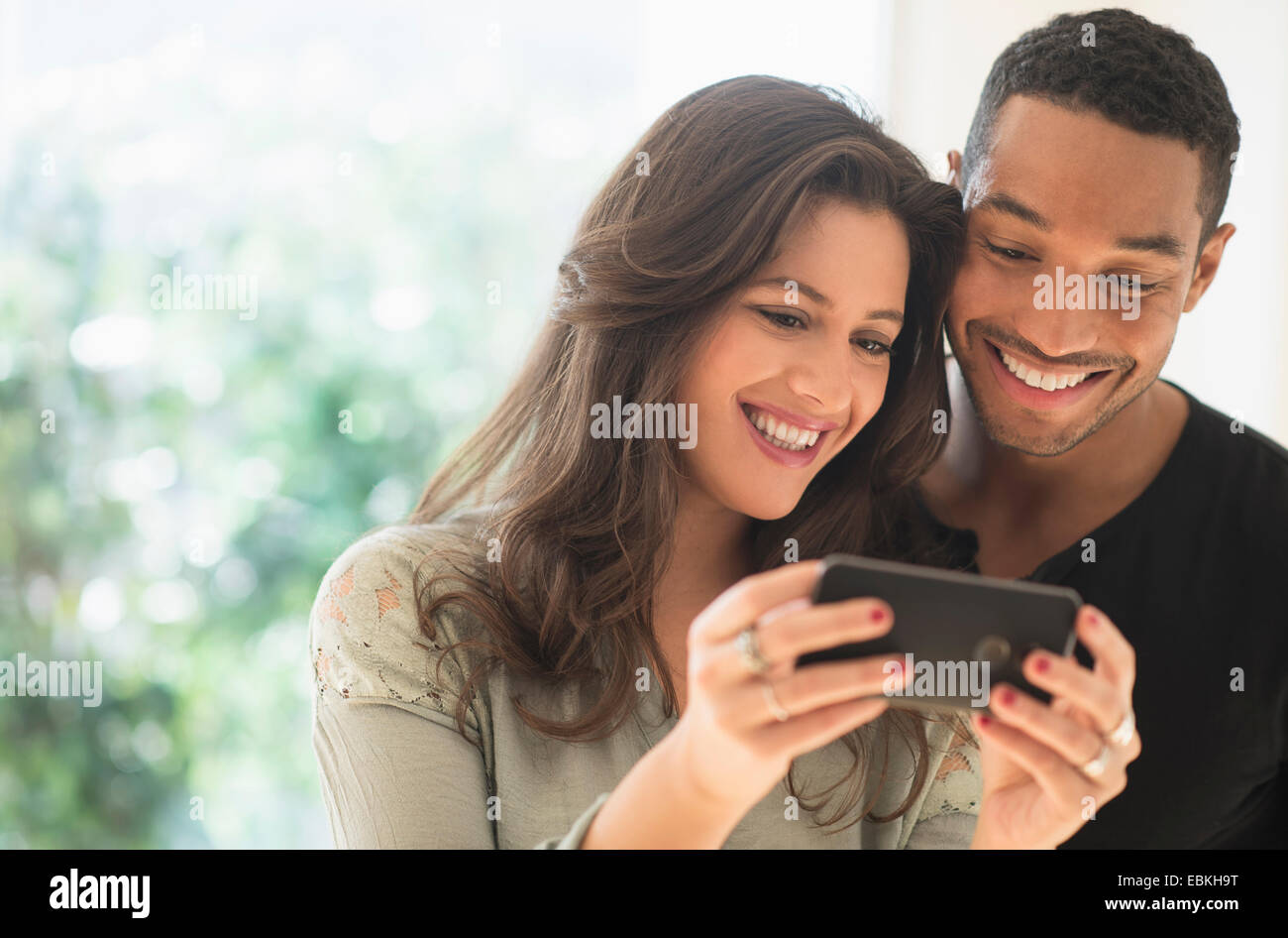 Couple looking at smartphone Stock Photo - Alamy