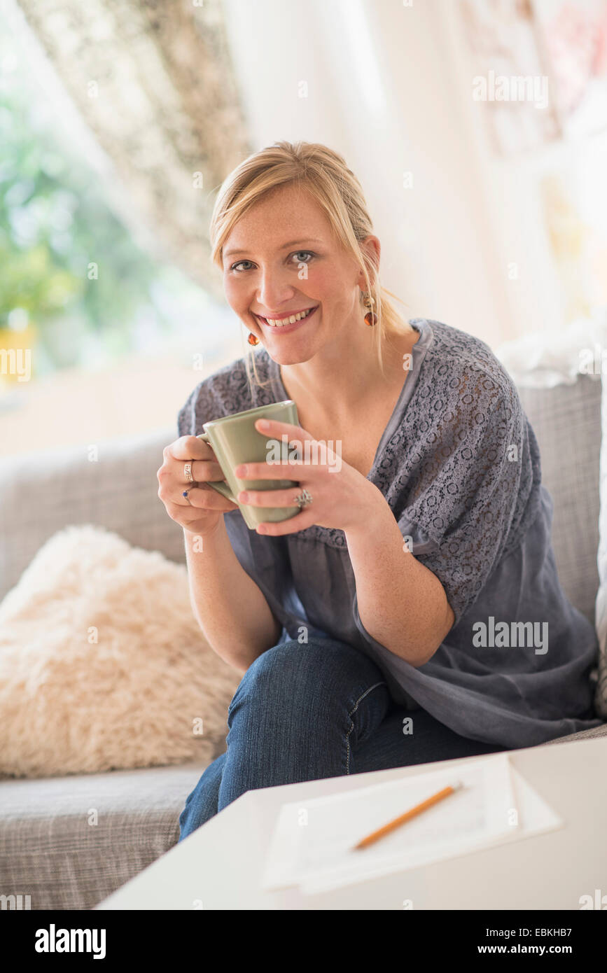 Woman sitting cup coffee hi-res stock photography and images - Alamy