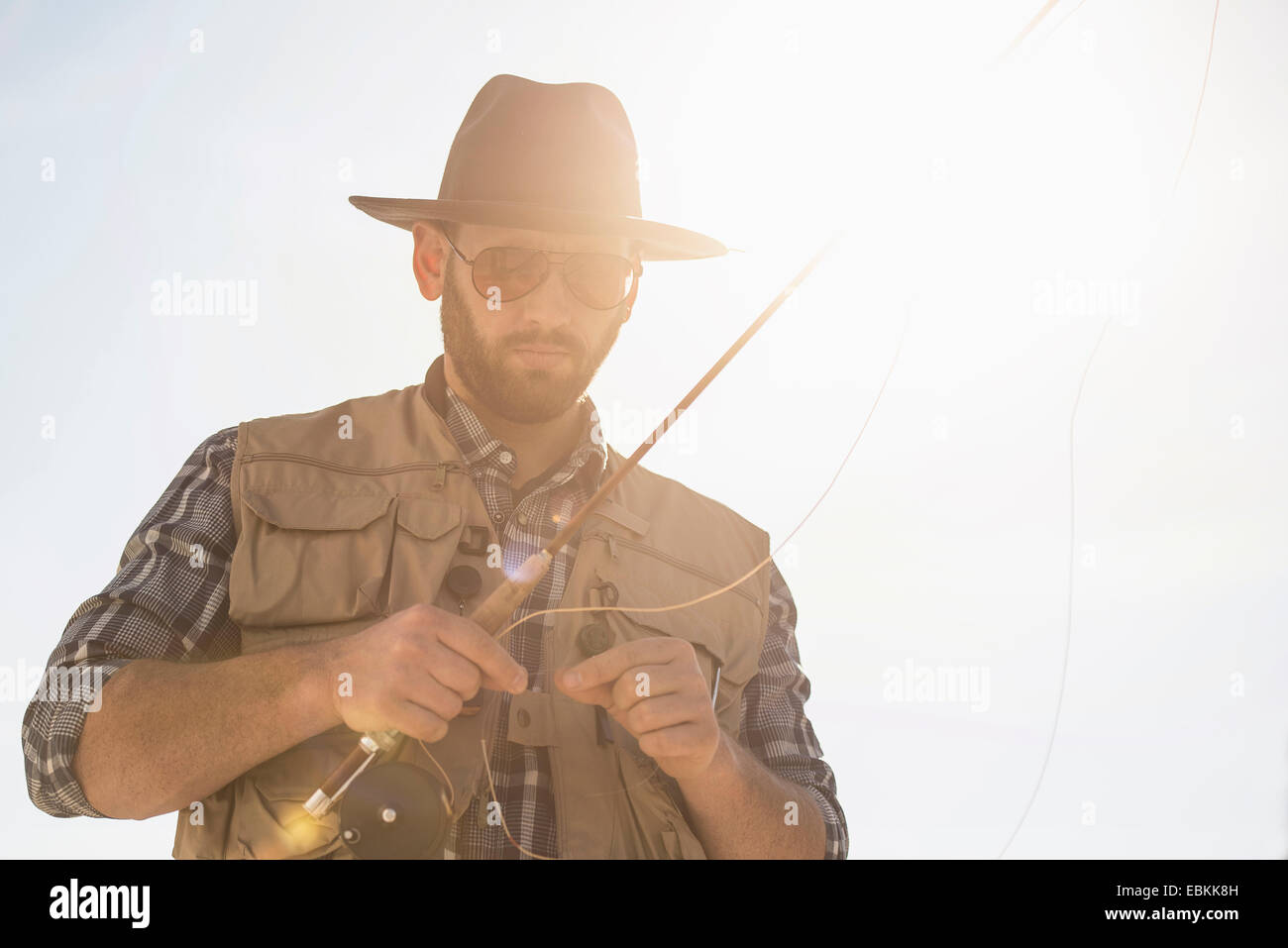 Portrait of man holding fishing rod Stock Photo - Alamy