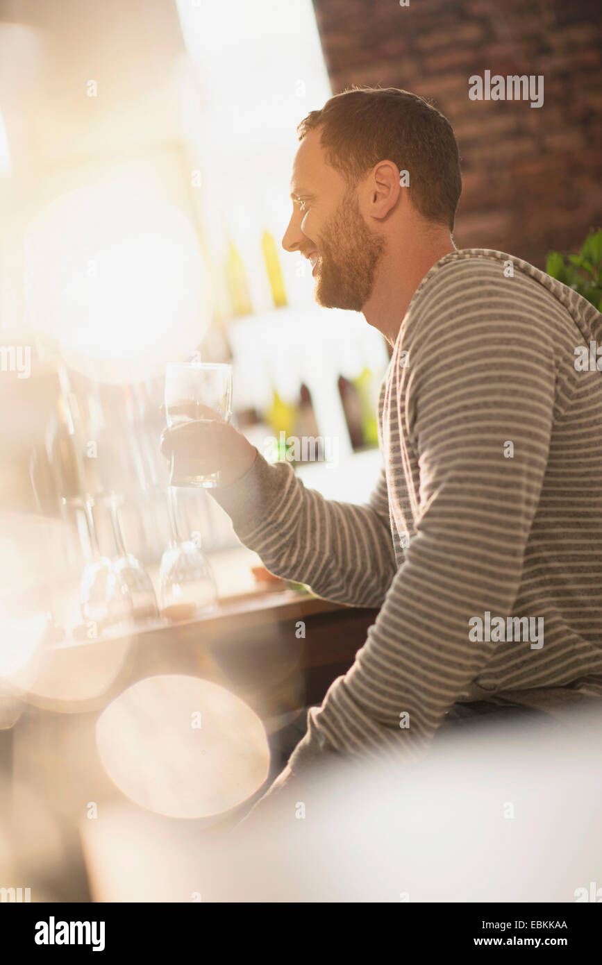 Side view of man having drink in bar Stock Photo - Alamy