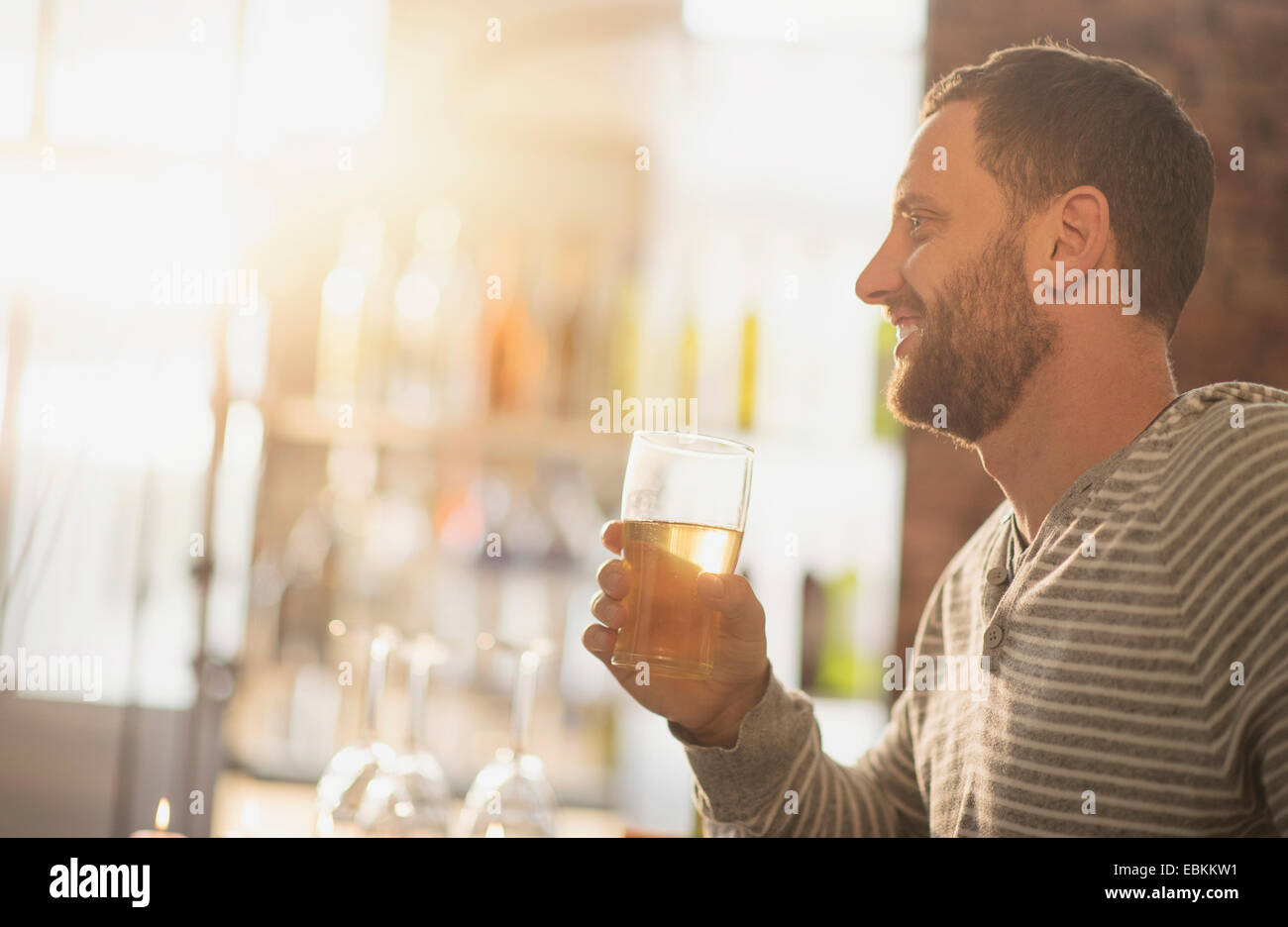 Side view of man having drink in bar Stock Photo - Alamy
