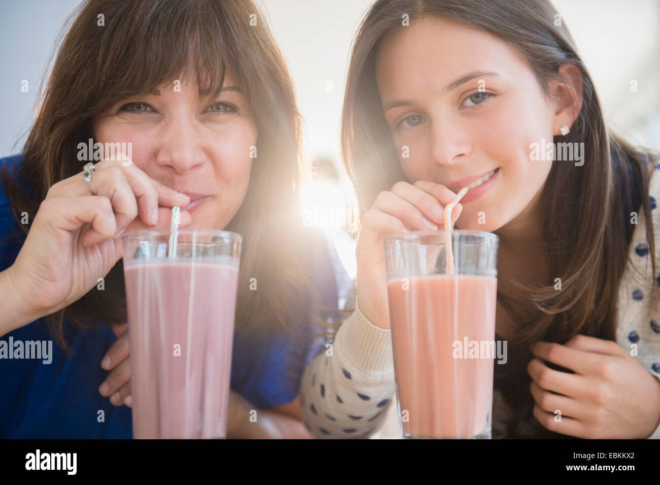Portrait of mother and daughter (14-15) drinking milkshakes Stock Photo ...