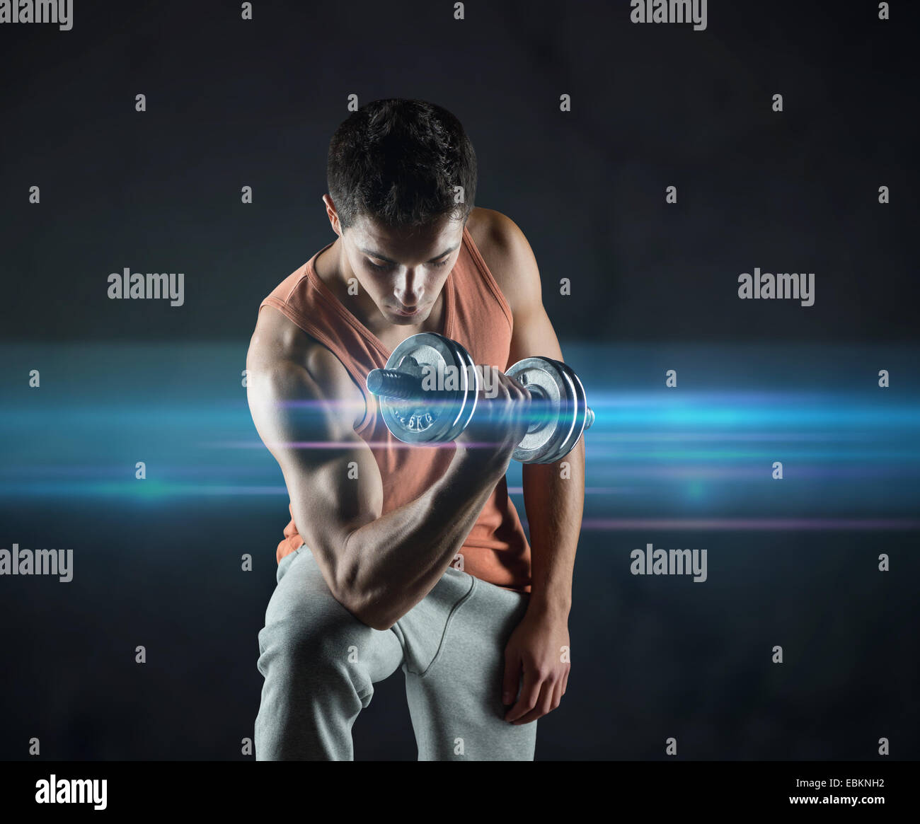 young man with dumbbell flexing biceps Stock Photo - Alamy