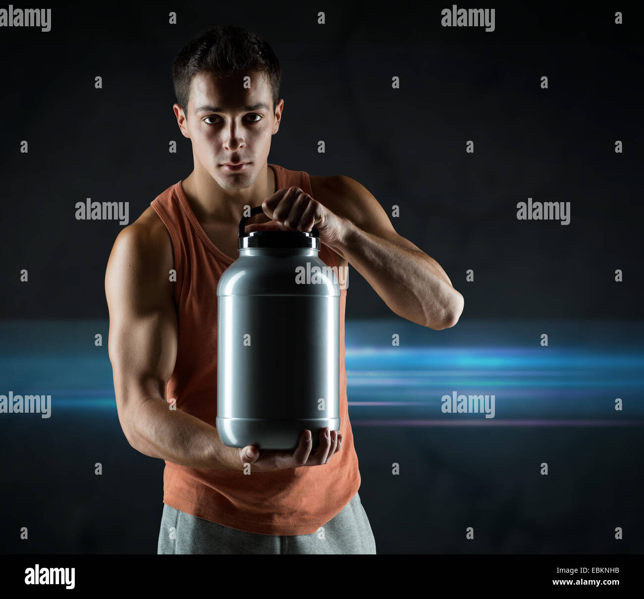young male bodybuilder holding jar with protein Stock Photo - Alamy