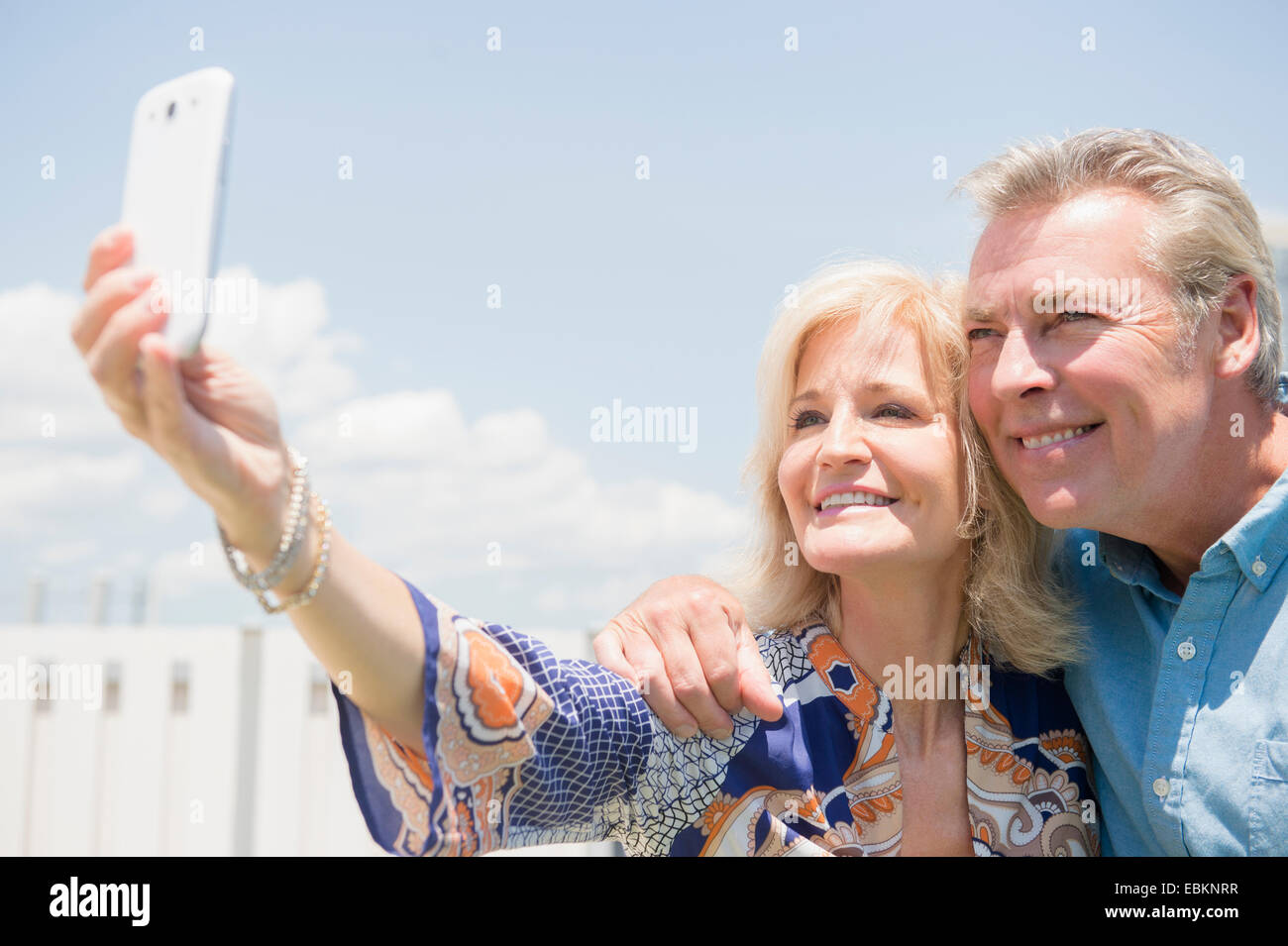 Portrait of couple posing for smartphone selfie Stock Photo - Alamy