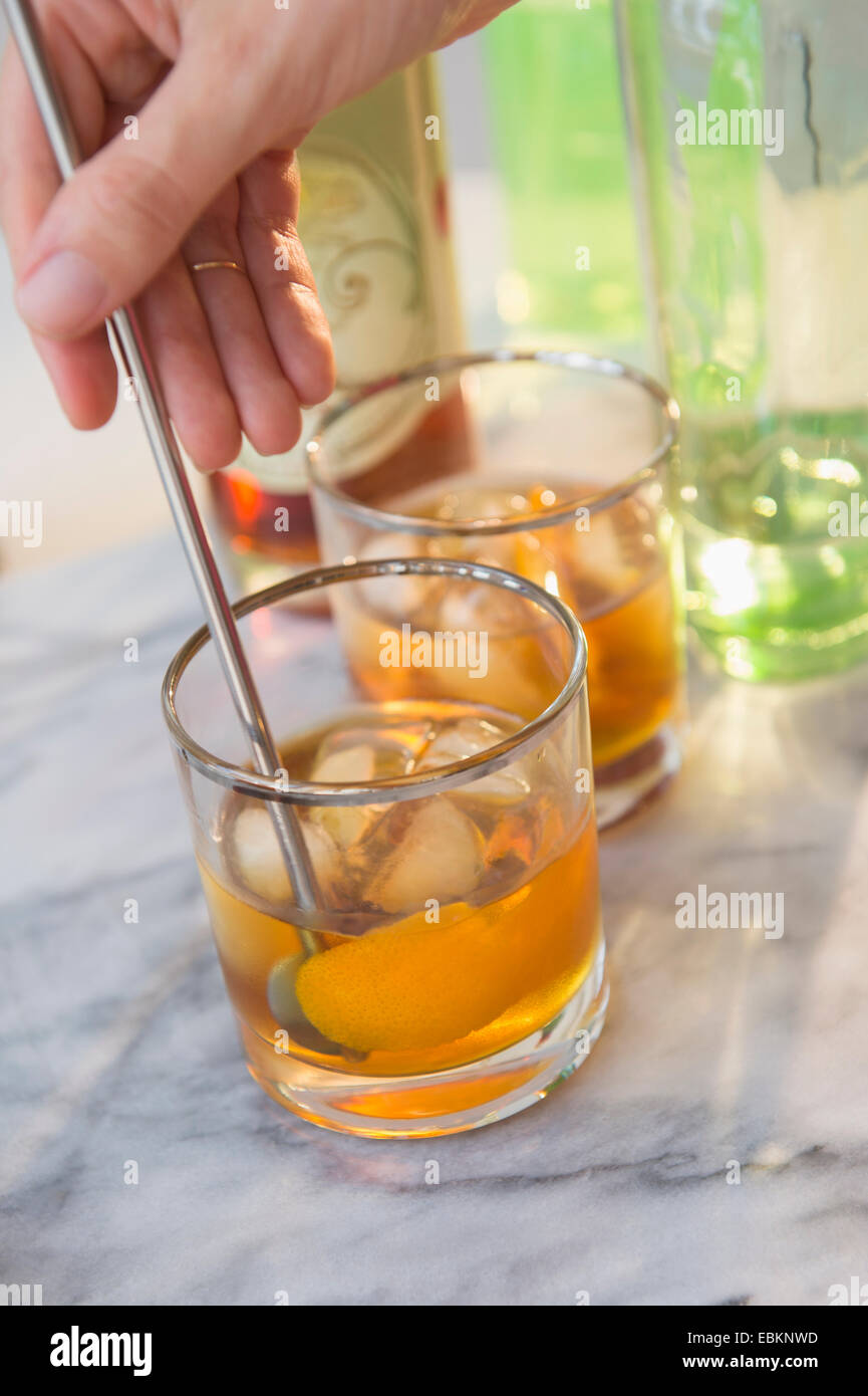 Studio shot of woman's hand stirring drink Stock Photo - Alamy