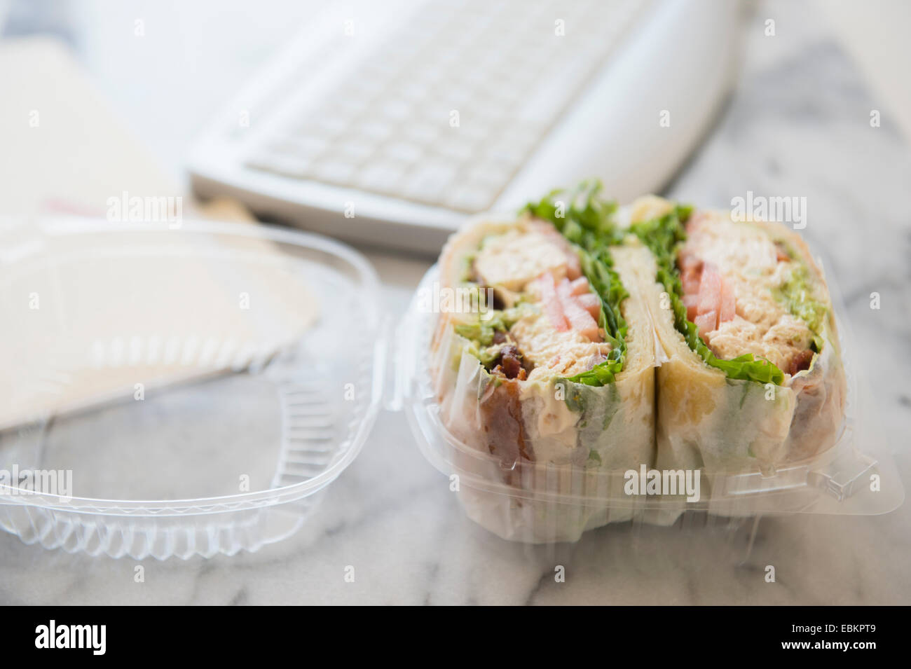Sandwich and computer keyboard at table in office hi-res stock ...
