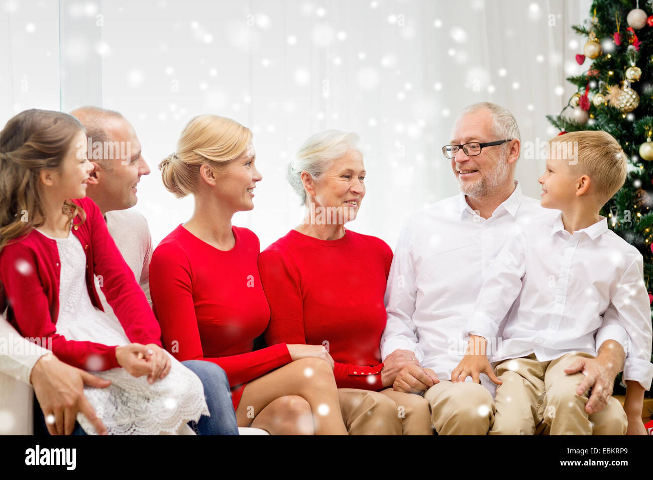 smiling family sitting and talking at home Stock Photo - Alamy