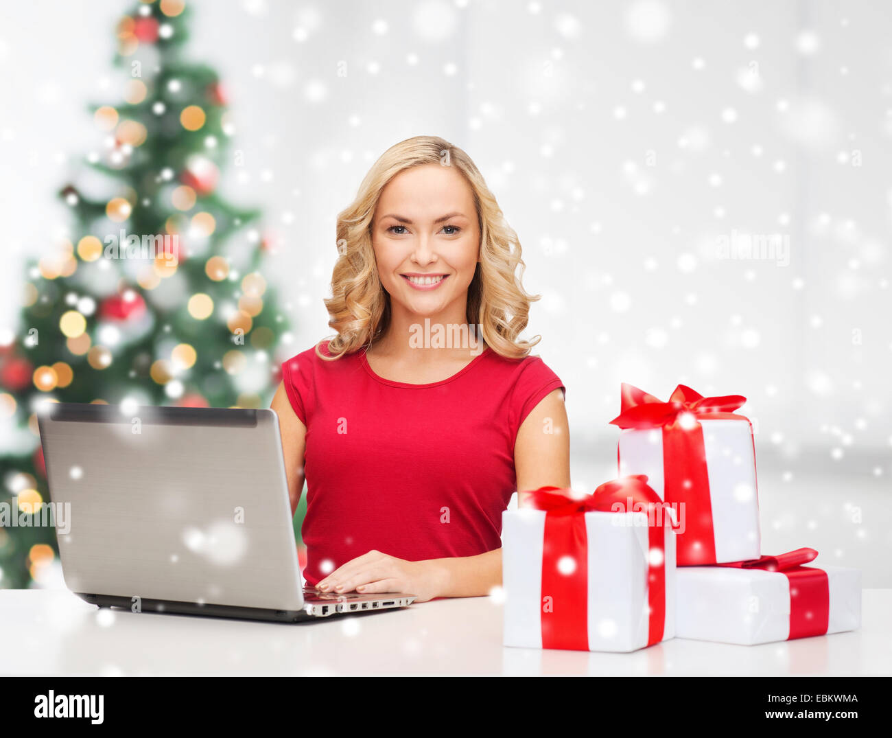 woman with gift boxes and laptop computer Stock Photo - Alamy