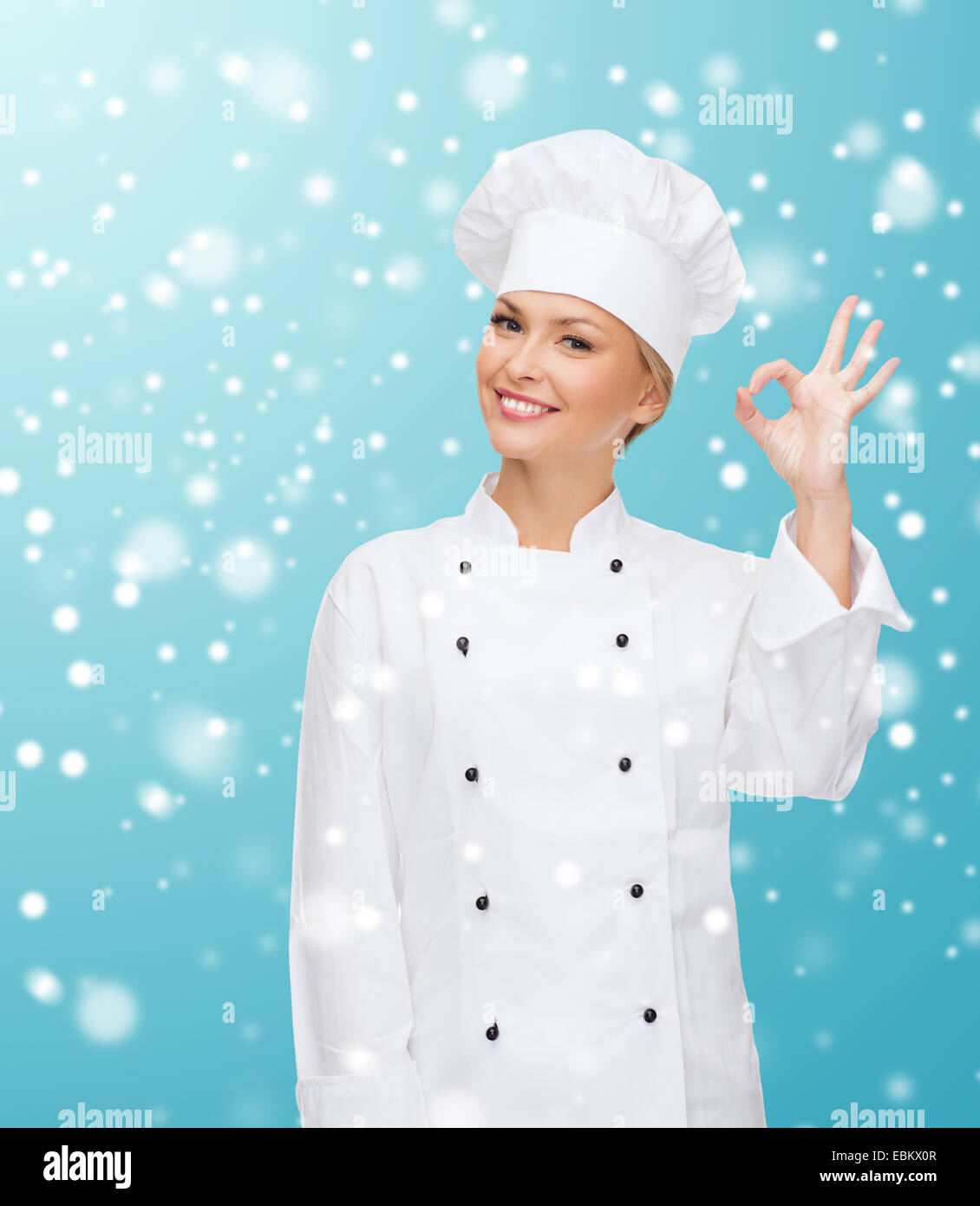smiling female chef showing ok hand sign Stock Photo - Alamy