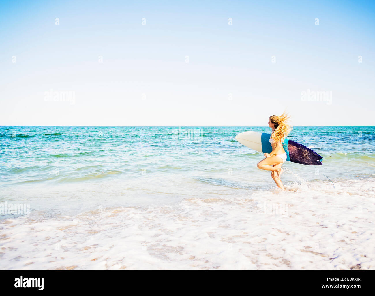 Woman running beach bikini hi-res stock photography and images - Alamy
