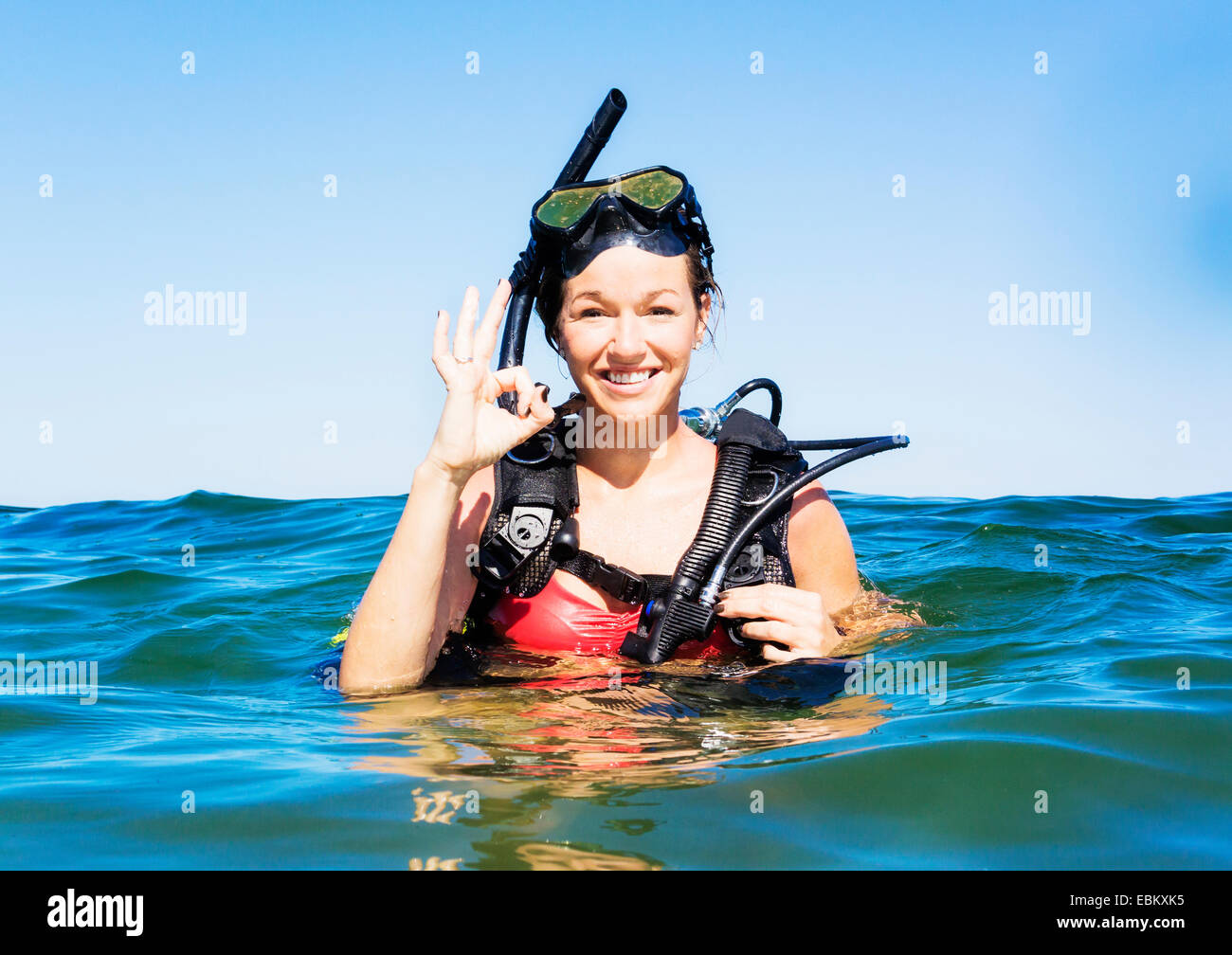 USA, Florida, Jupiter, Portrait of young woman scuba-diving in sea ...