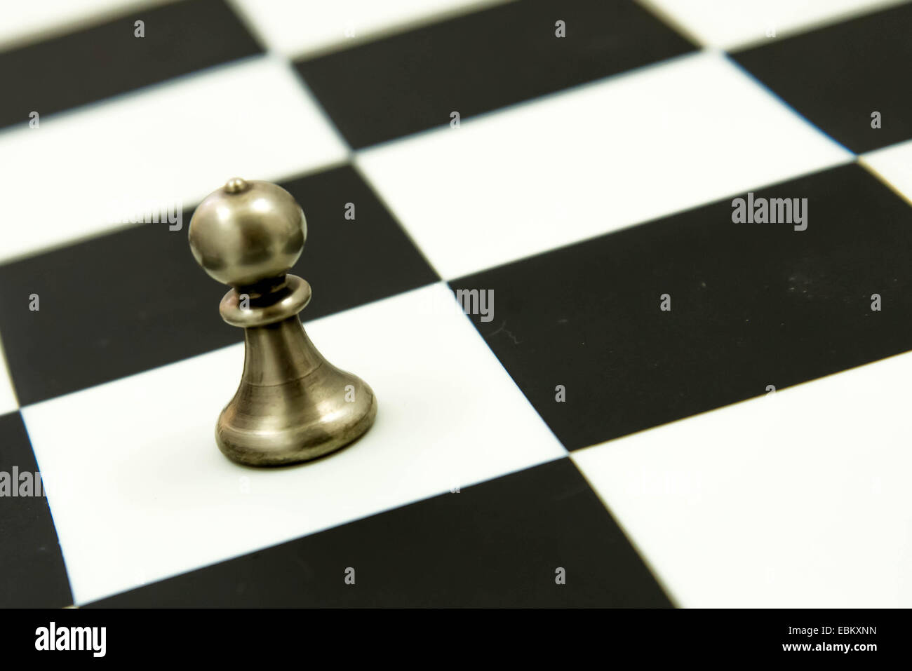 Classic chess game - pawn alone in front on chessboard Stock Photo - Alamy