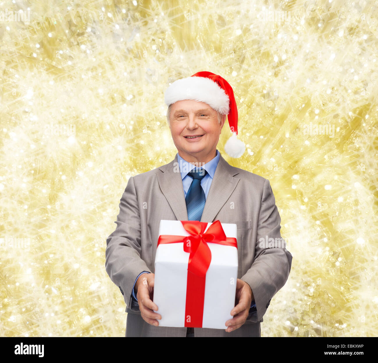 smiling man in suit and santa helper hat with gift Stock Photo - Alamy