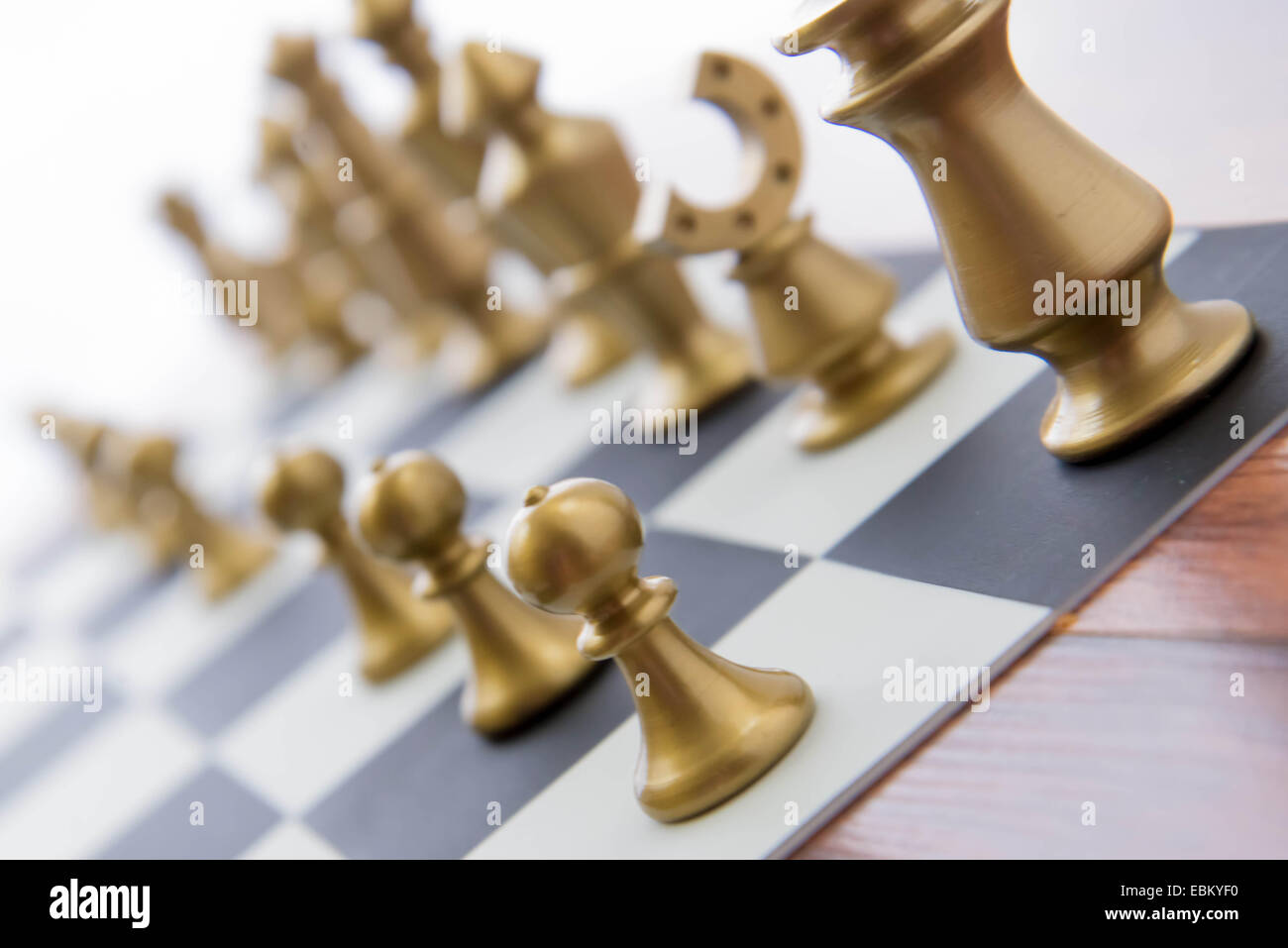 Classic chess game - gold playing pieces lined up on chessboard Stock ...