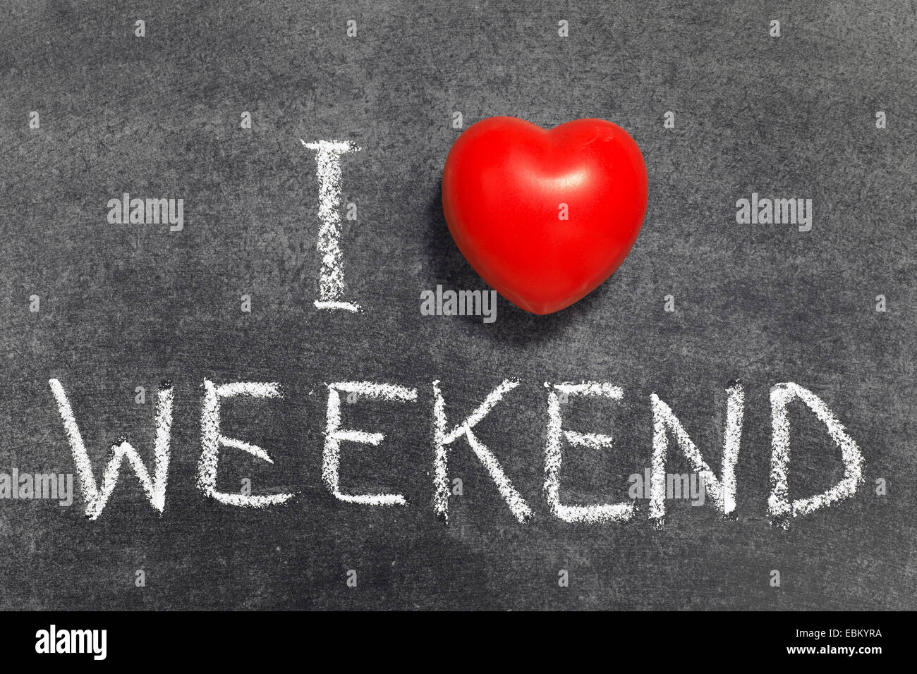 I love weekend phrase handwritten on blackboard with red heart symbol ...