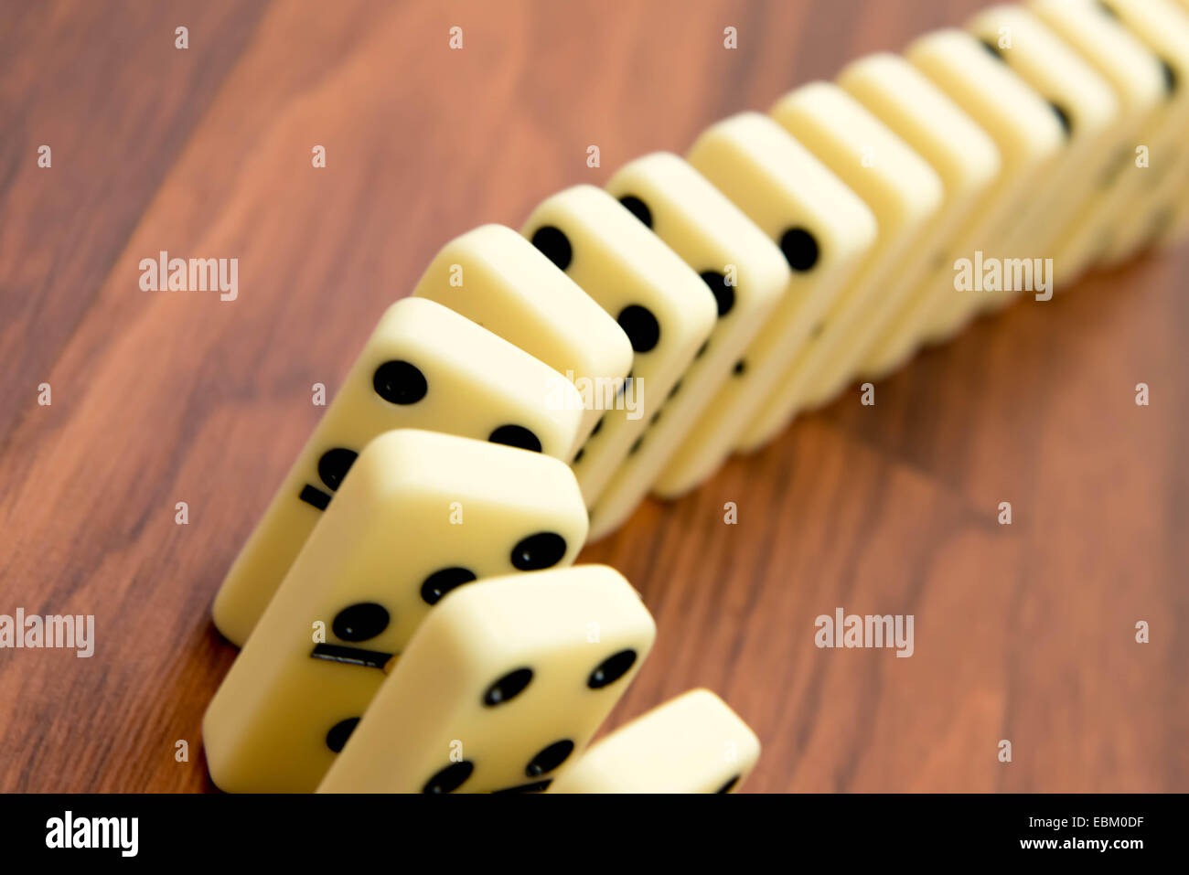 Domino tiles standing vertically in a line Stock Photo - Alamy