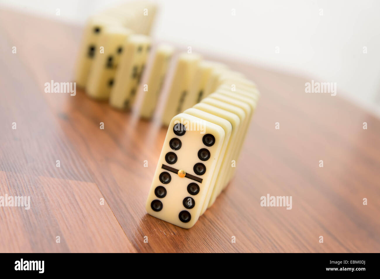 Domino tiles standing vertically in a line Stock Photo - Alamy