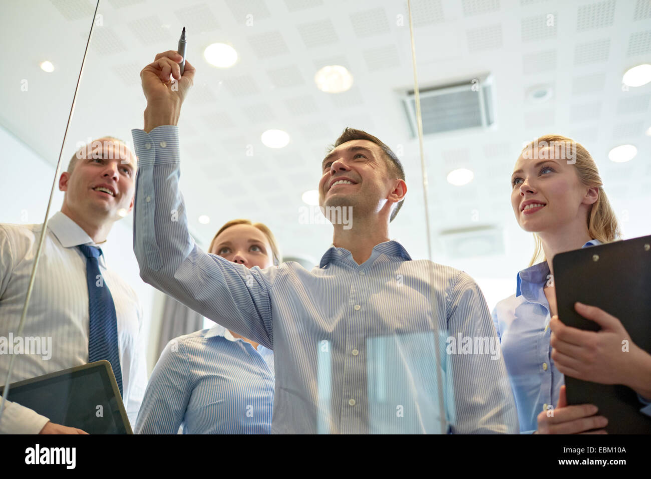 smiling business people with marker and stickers Stock Photo - Alamy