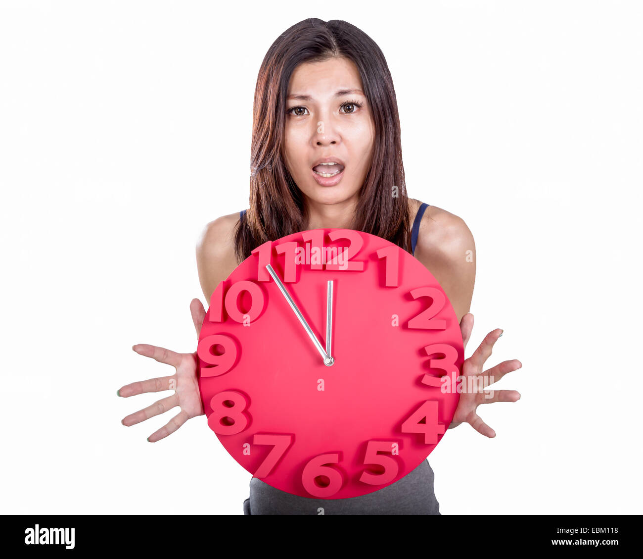 Chinese woman looking worried, holding clock showing five to twelve ...