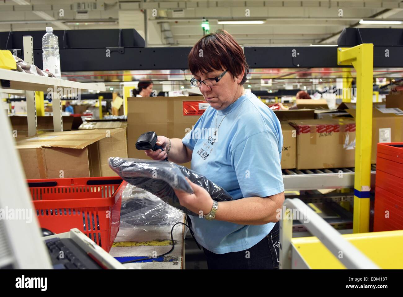 A staff member is busy at work scanning packages in the logistics and ...