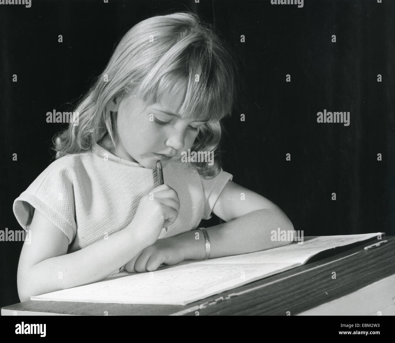 YOUNG GIRL STUDYING Stock Photo - Alamy
