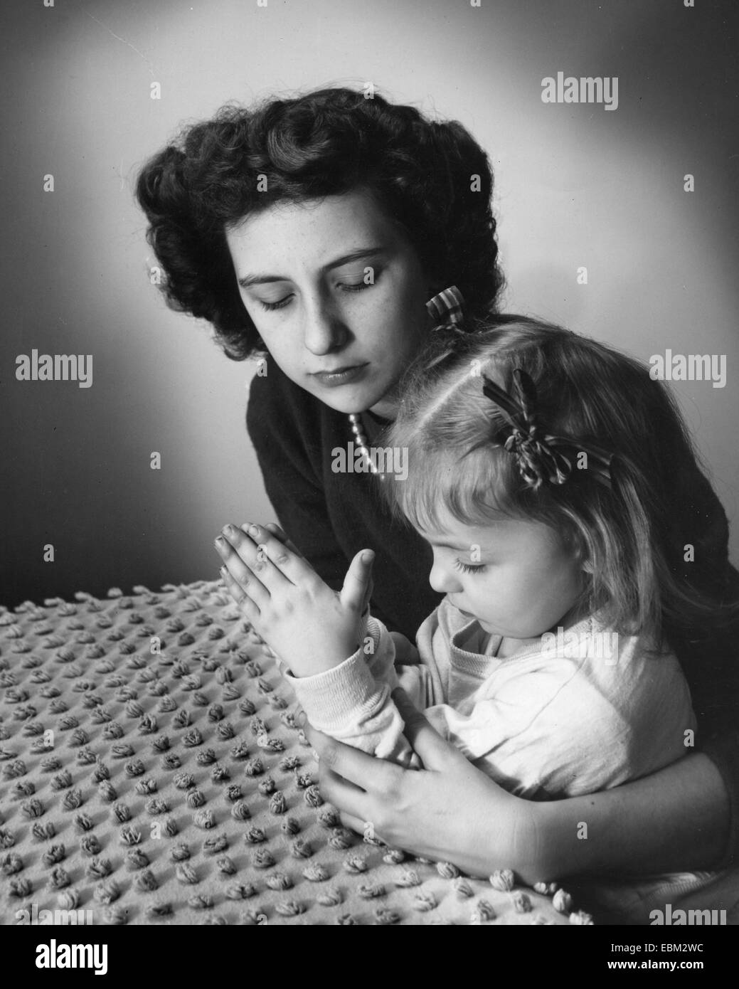 MOTHER AND CHILD IN PRAYER Stock Photo - Alamy