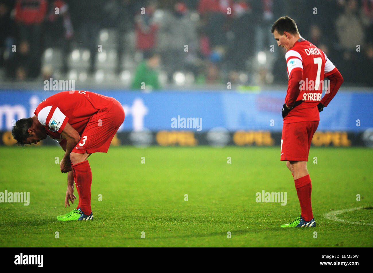 Freiburg's Marc Torrejon (l) and Vladimir Darida (r) stand on the pitch ...