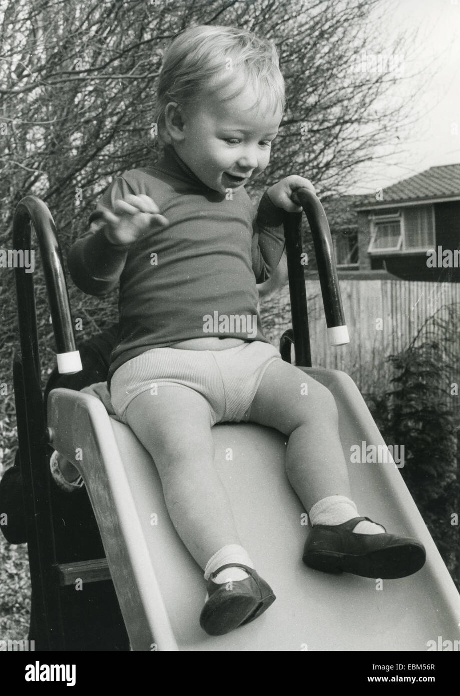 HAPPY BOY ON SLIDE. Photo Tony Gale Stock Photo - Alamy