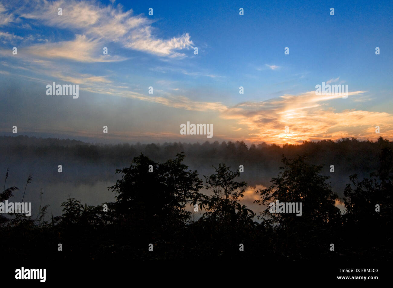 Pond with mist rising at sunrise near Patoka River National Wildlife ...